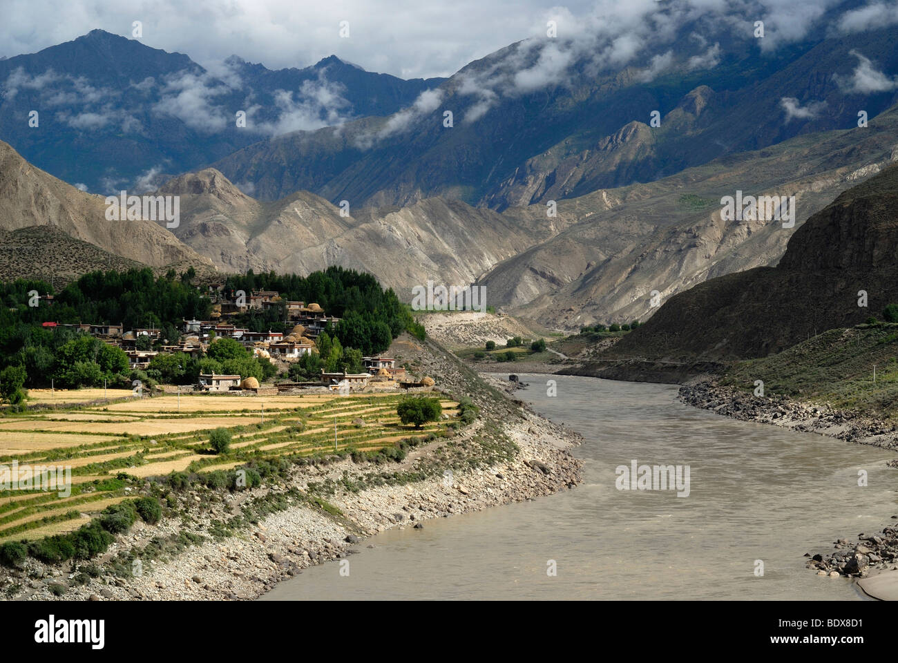 Tibetan village in front of grainfields in the valley of the Yarlung ...