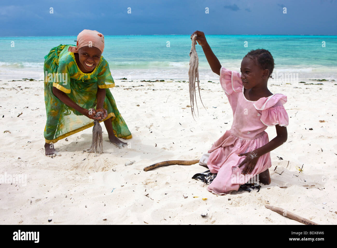 Children beating an octopus with sticks in order to make it edible ...
