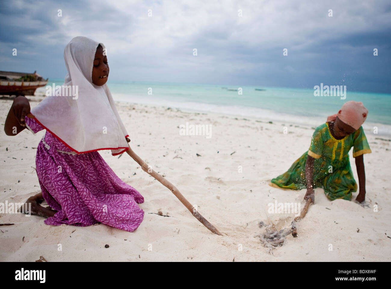 Children beating an octopus with sticks in order to make it edible ...