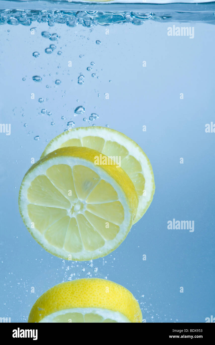 Yellow lemon slices falling water hi-res stock photography and images - Alamy