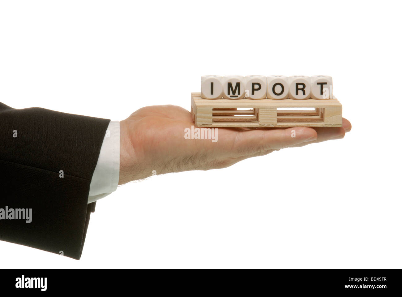 Business man with pallet with the lettering import Stock Photo - Alamy