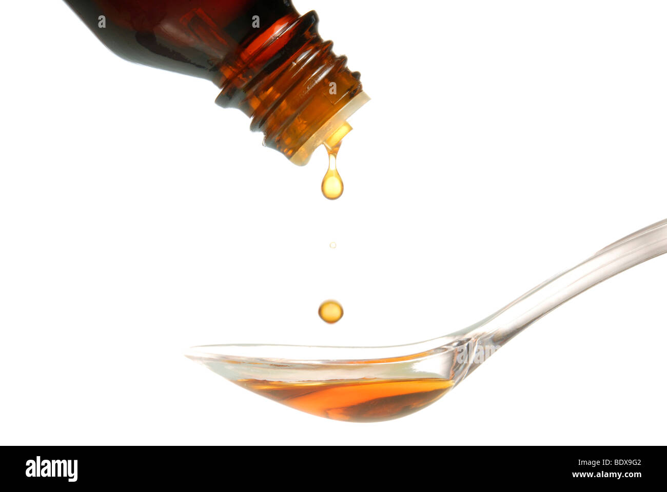 Medicinal drops falling onto a spoon, symbolic image for health Stock ...