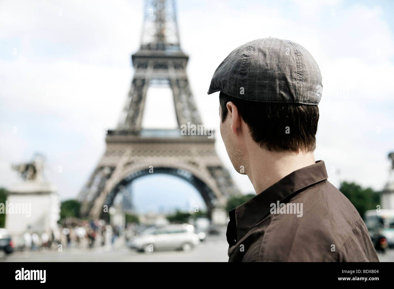 Young man glancing at the Eiffel Tower, Paris, France, Europe Stock ...