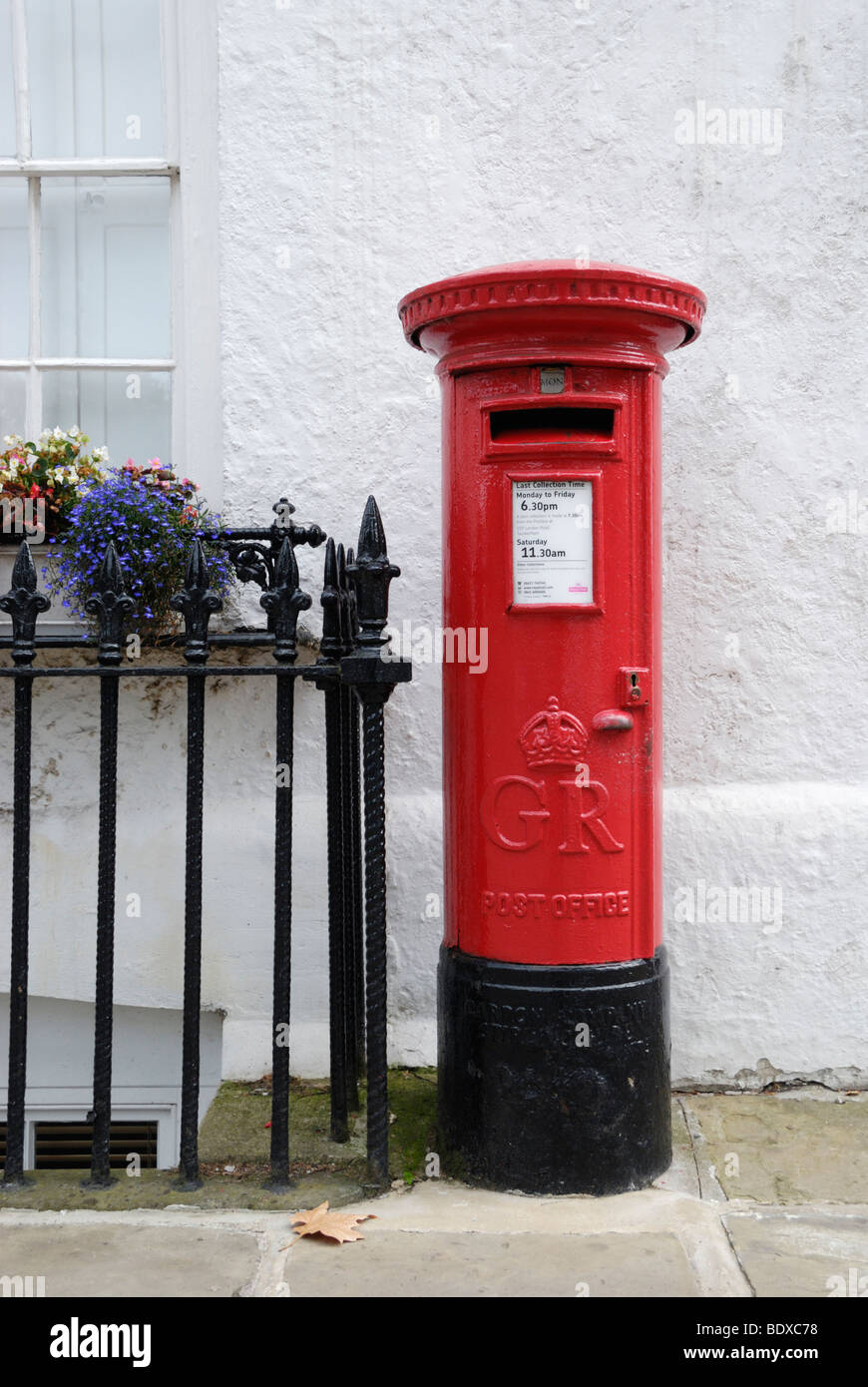Traditional British red pillar box against whitewashed wall Stock Photo ...