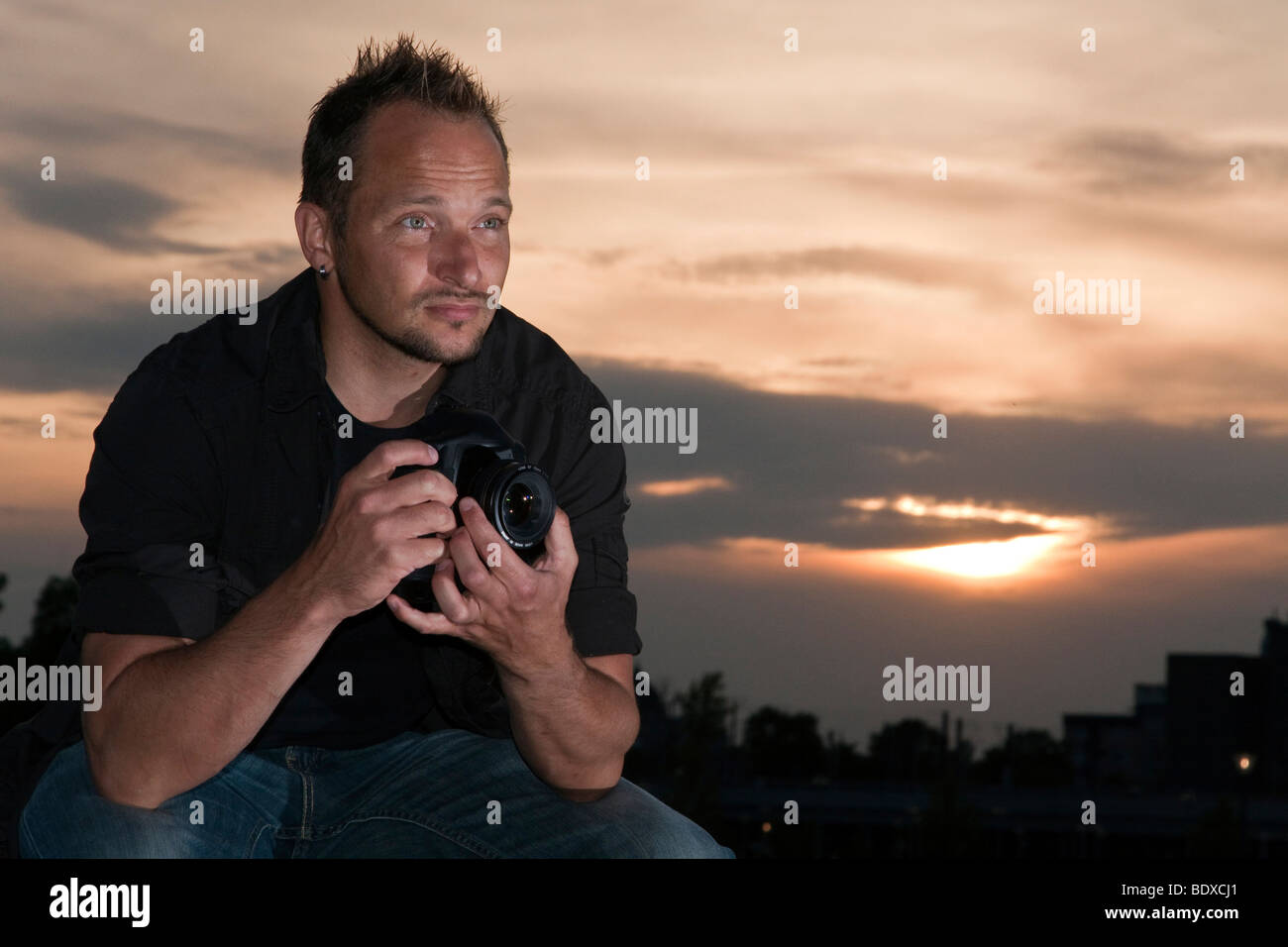 Photographer waiting for the right lighting and motif Stock Photo - Alamy