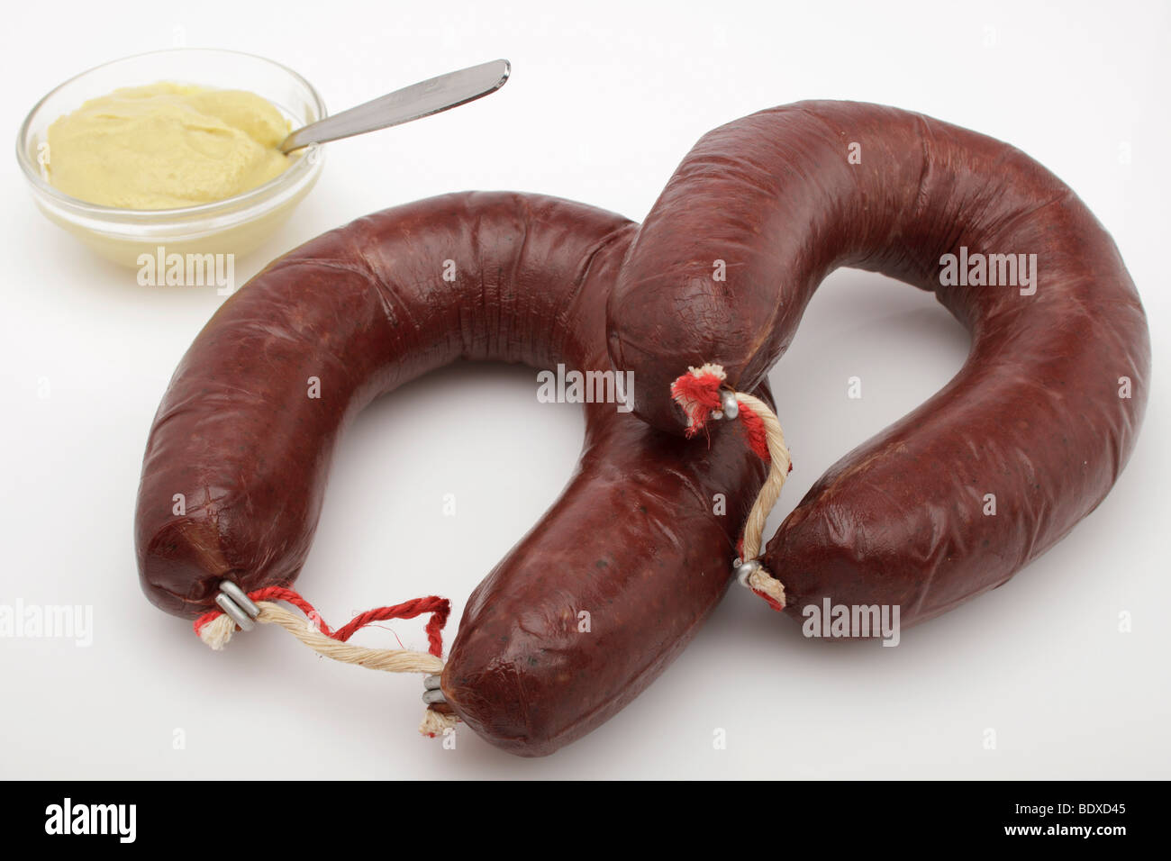 Rings of black pudding with mustard Stock Photo - Alamy