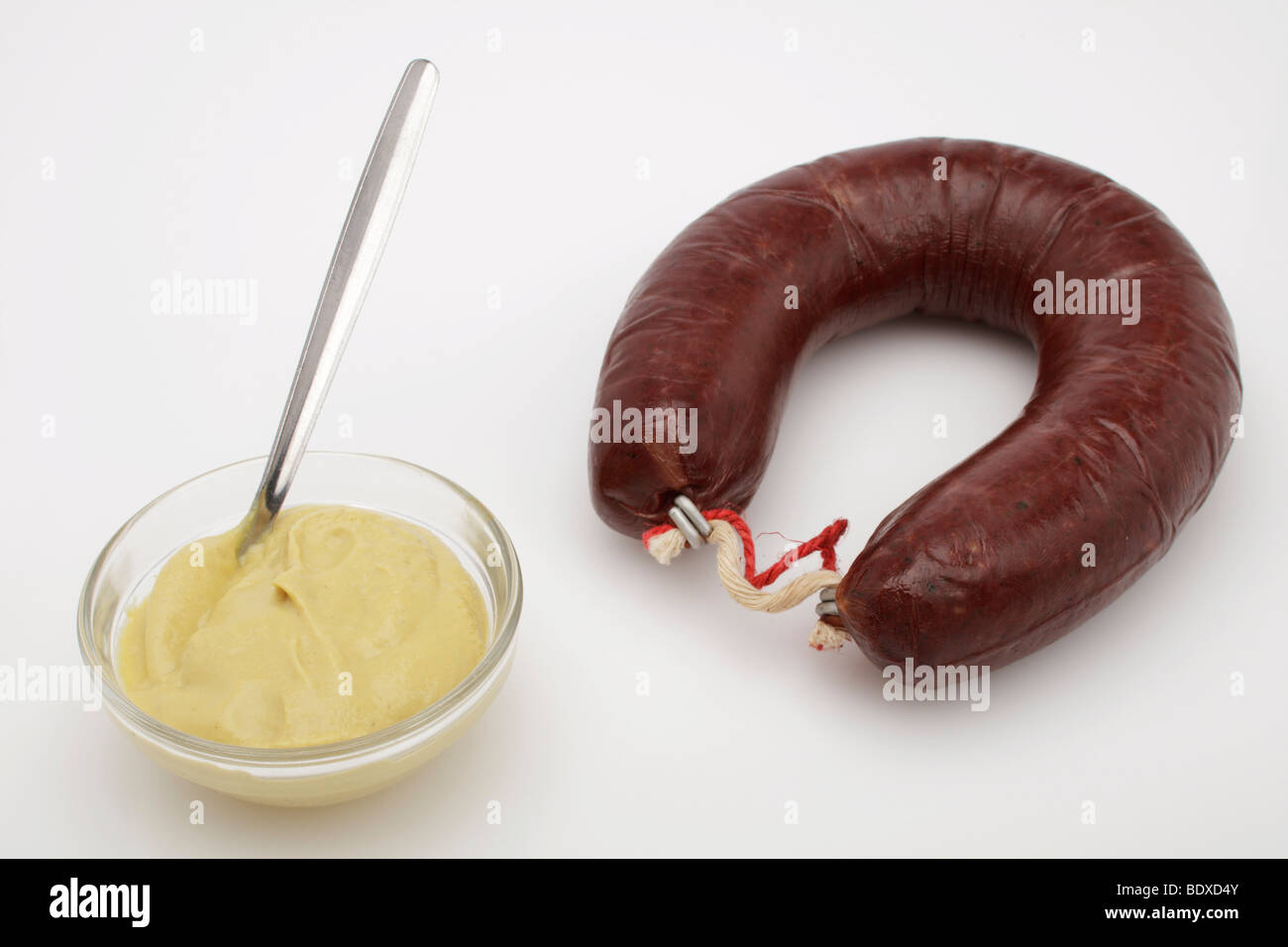Ring of black pudding with mustard Stock Photo - Alamy