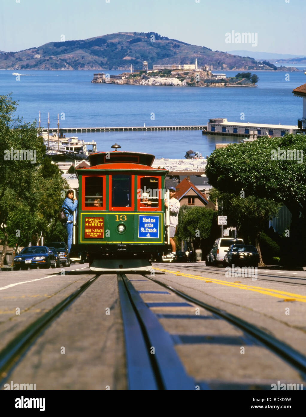 Cable car climbing up Hyde Street with Alcatraz Island in San Francisco ...