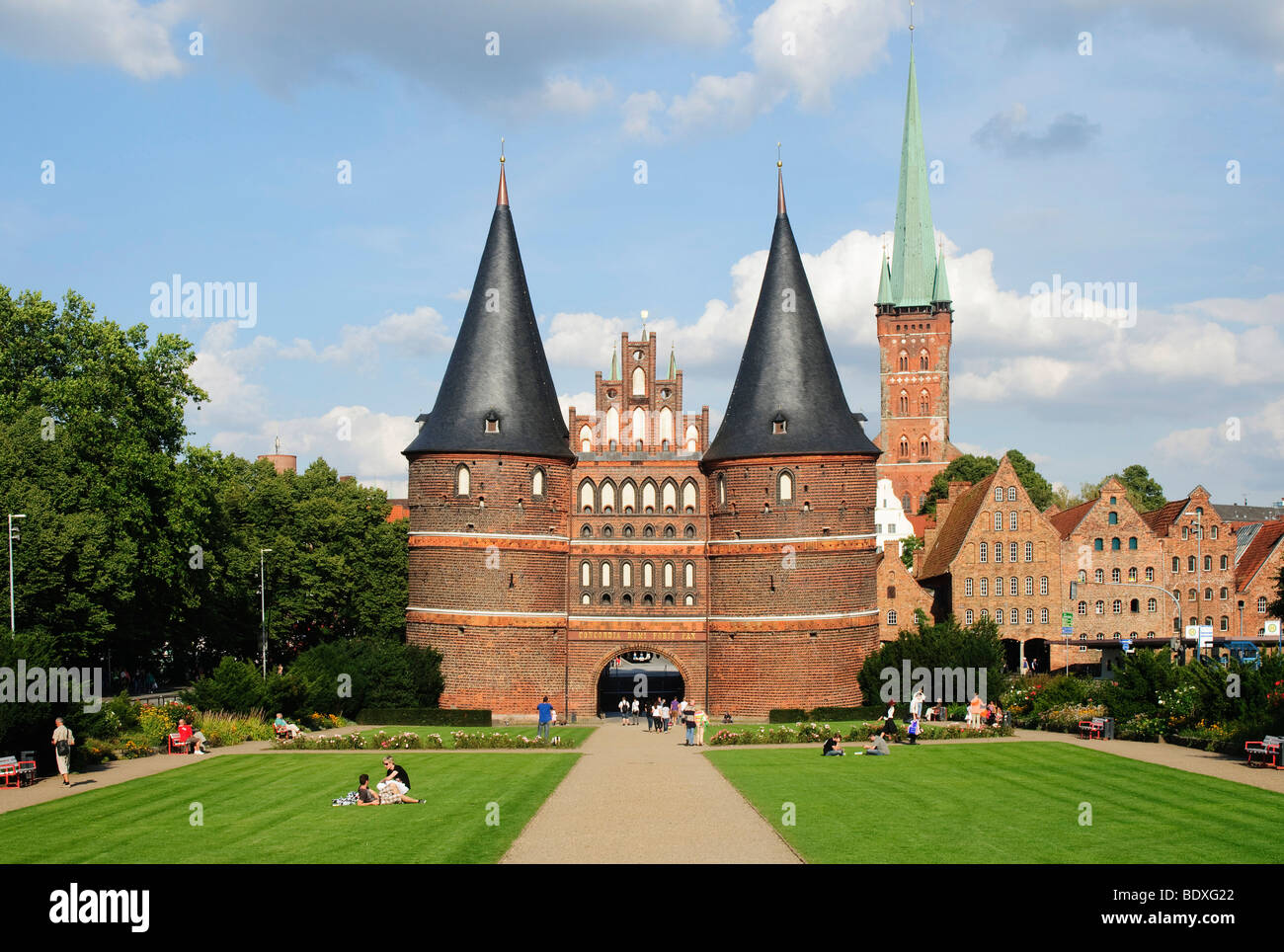 The Holstentor, Holsten Gate, in Luebeck, in the back the church of St ...