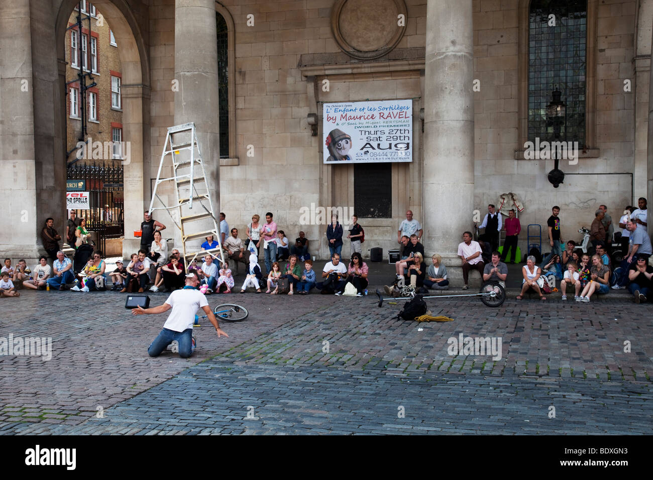 Busking street performer plays for an audience of onlookers at Covent ...