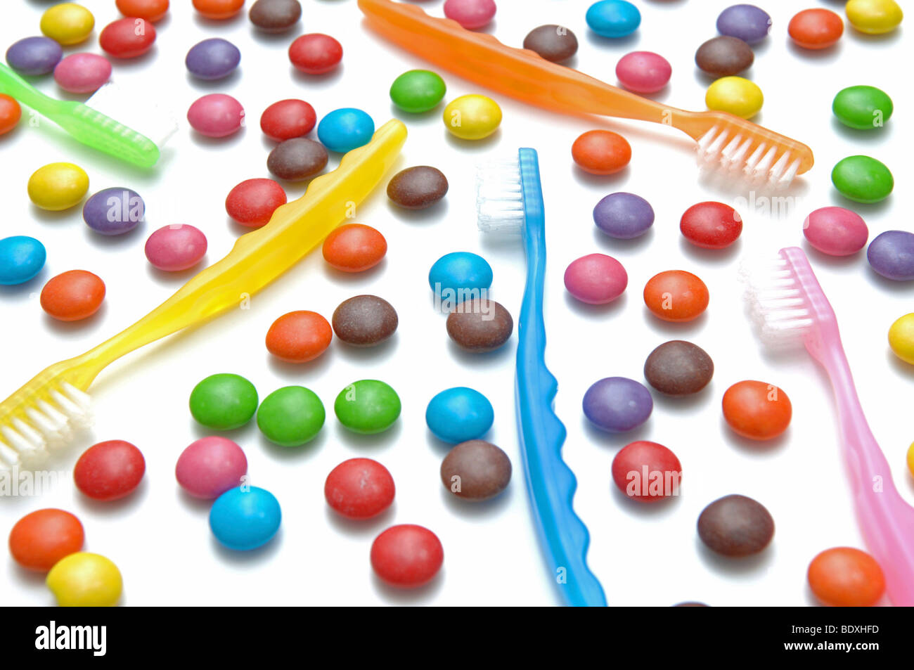 Colorful chocolate candies and toothbrushes Stock Photo - Alamy