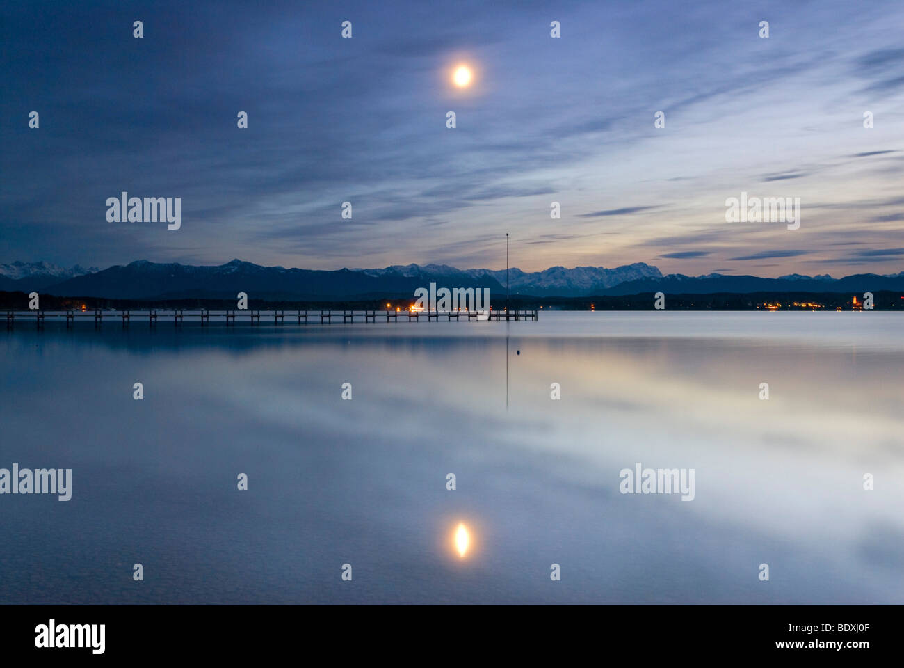 Full moon and its reflection in Lake Starnberg with the Bavarian Alps ...
