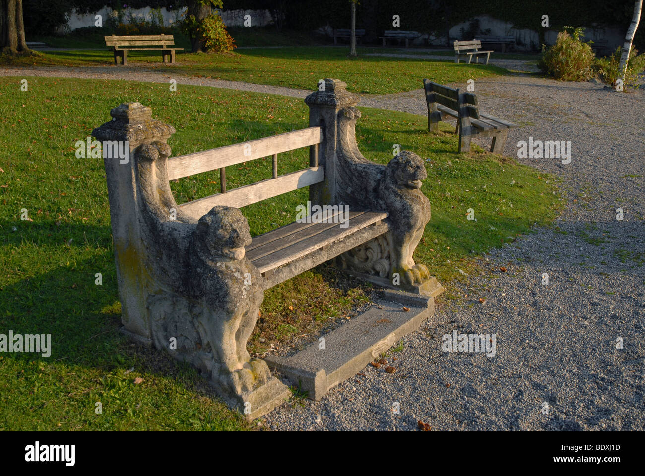 An old stone bench illuminated by soft morning light near Lake ...