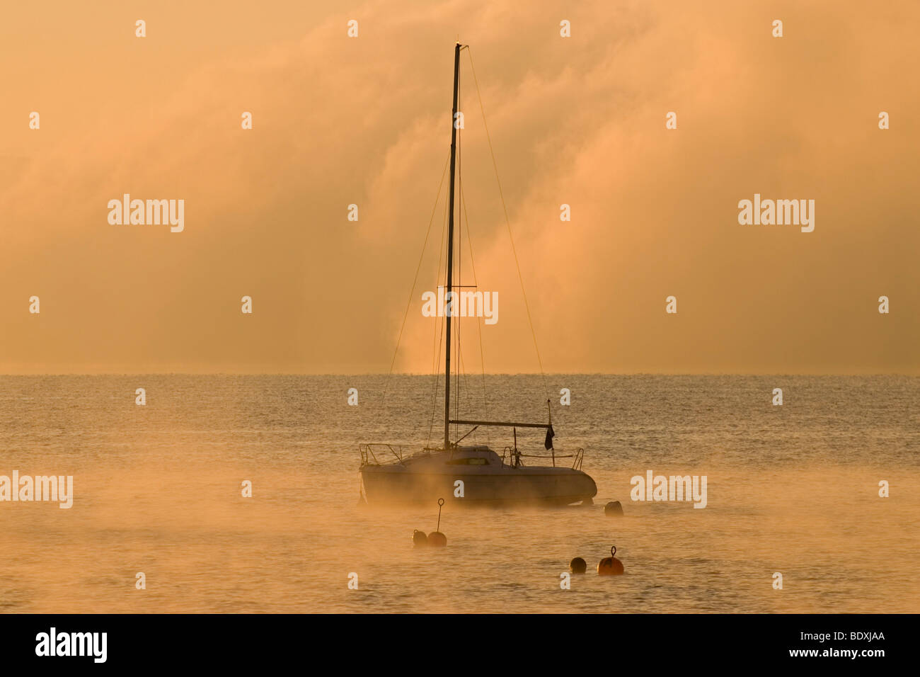 Sailing boat and low morning fog over Ammersee lake at Utting, Bavaria ...