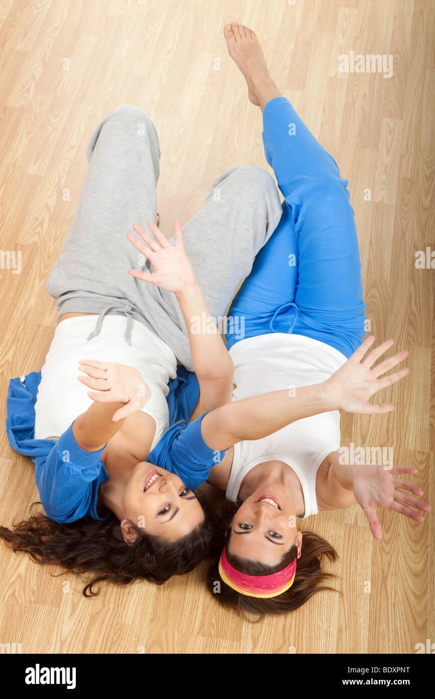 Two beautiful young women having fun and moving the Hands and Feet ...