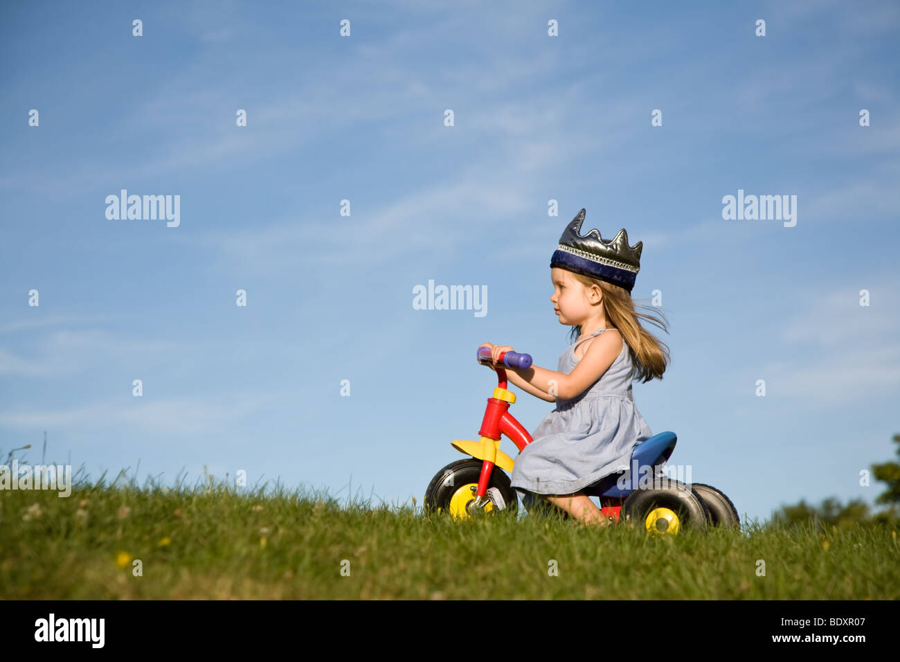 Toddler girl playing tricycle hi-res stock photography and images - Alamy
