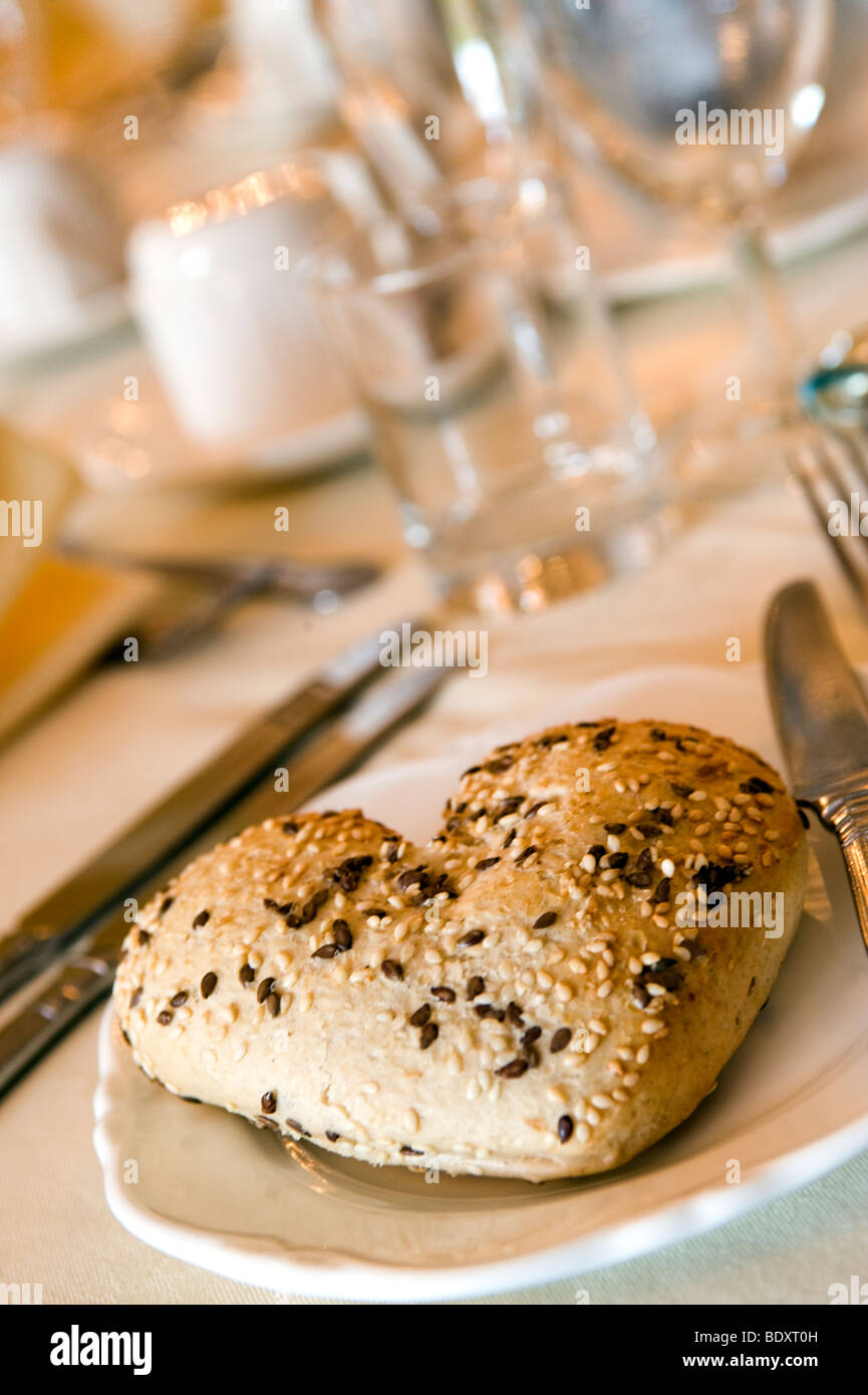 A Heart shaped seeded bread roll on a side plate Stock Photo - Alamy