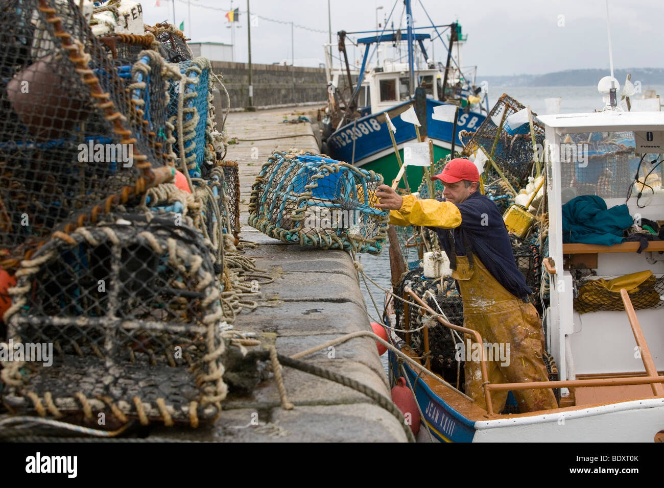 Fisherman loading loobster baskets on his boat before going out fishing ...