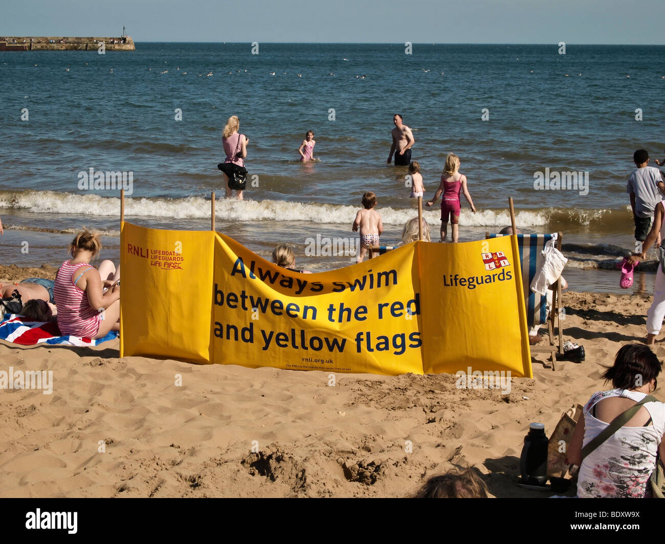 Lifeguard warning sign on UK beach Stock Photo - Alamy