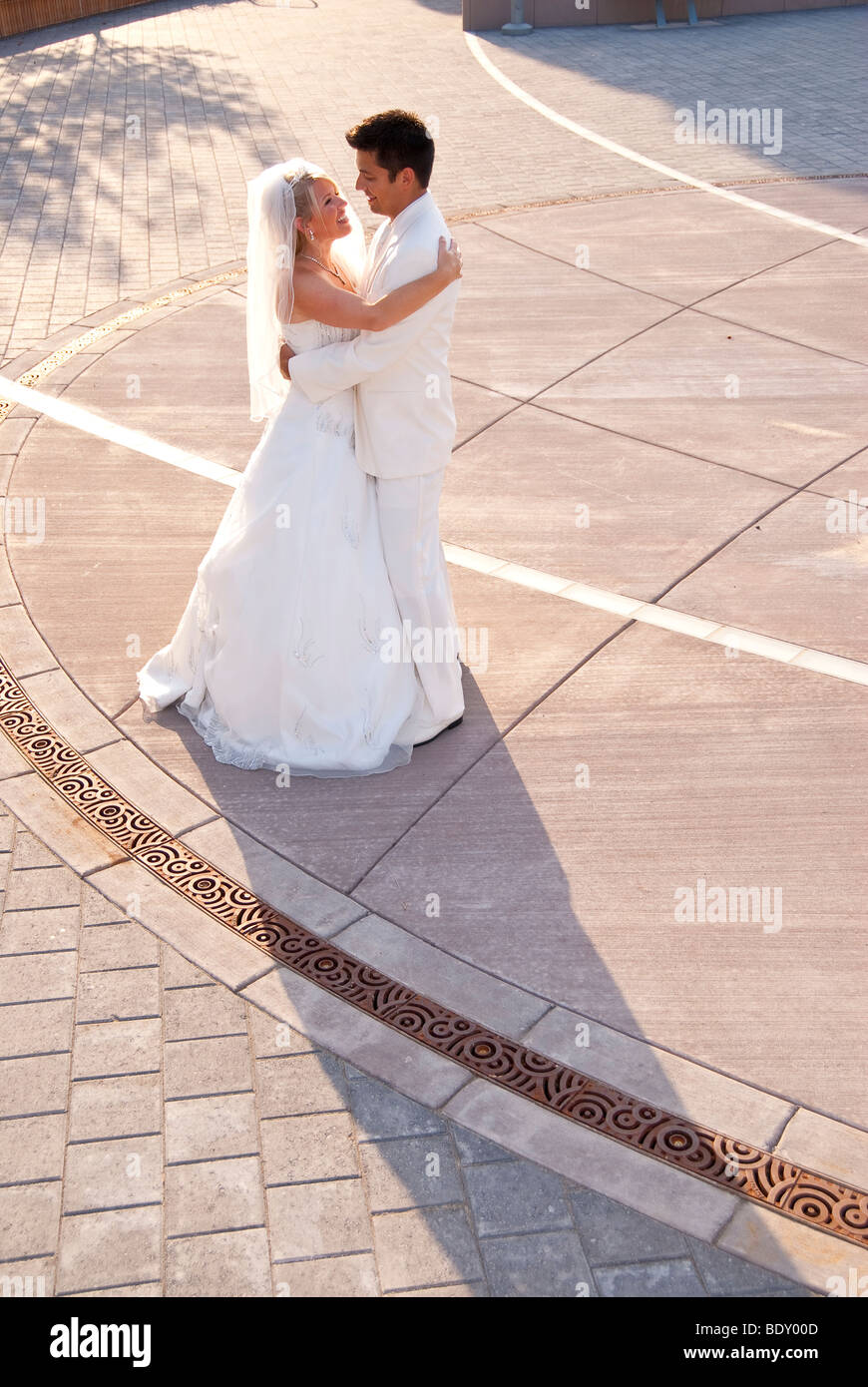 A wedding couple celebrate their wedding in a local park Stock Photo ...