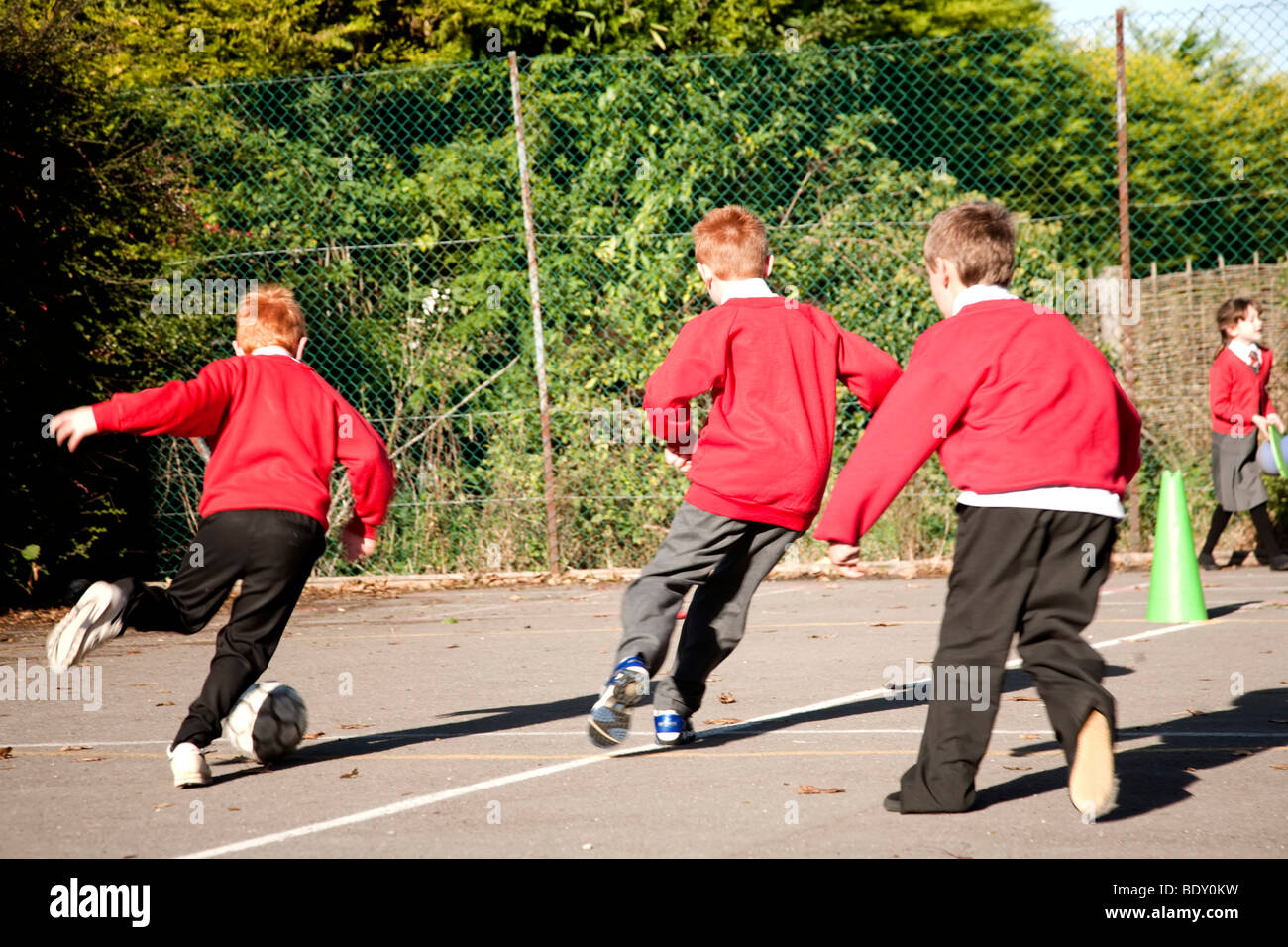 Schoolboys playing football Stock Photo - Alamy