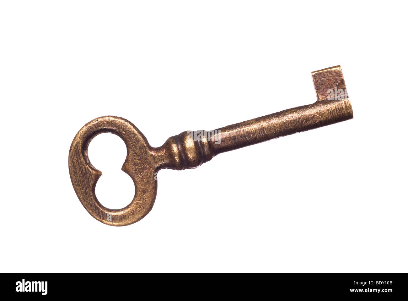A brass skeleton key isolated on a white background Stock Photo - Alamy