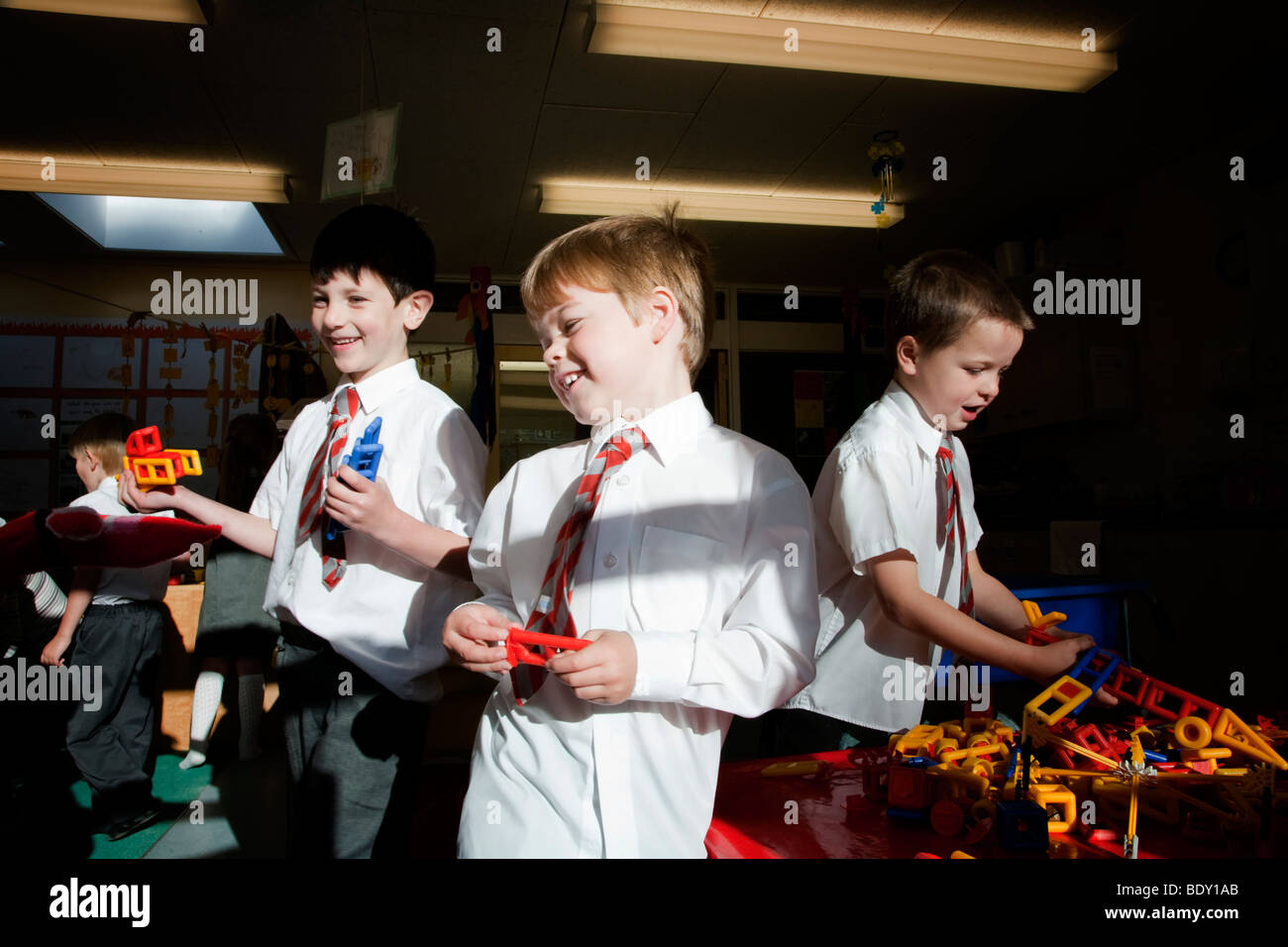 three schoolboys laughing in primary school classroom Stock Photo - Alamy