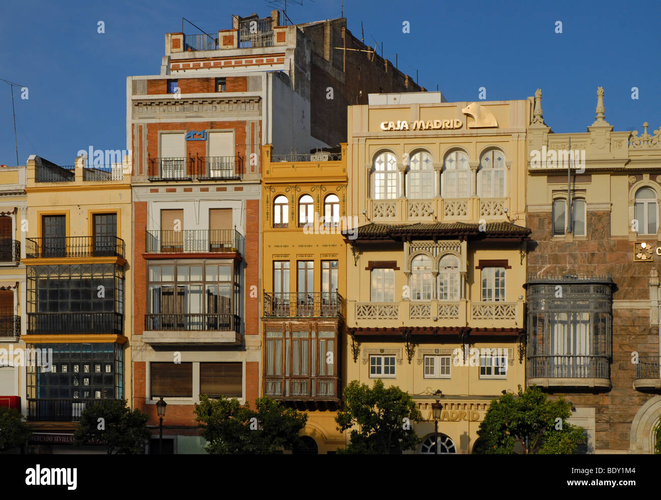 Facades of downtown Seville, illuminated by soft evening light, Spain ...