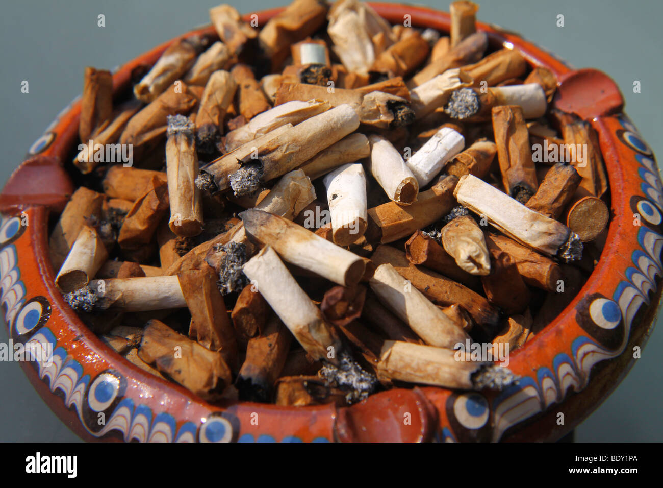Closeup vertical view of a full ashtray Stock Photo - Alamy