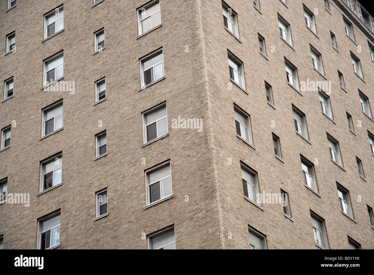Windows of brick city apartment building Stock Photo - Alamy