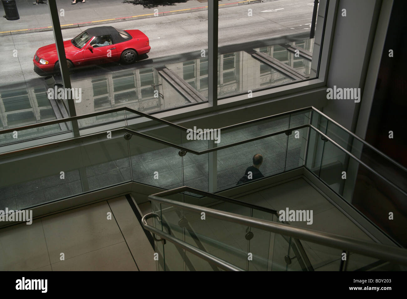 Looking outside at city street, man walking past window Stock Photo - Alamy