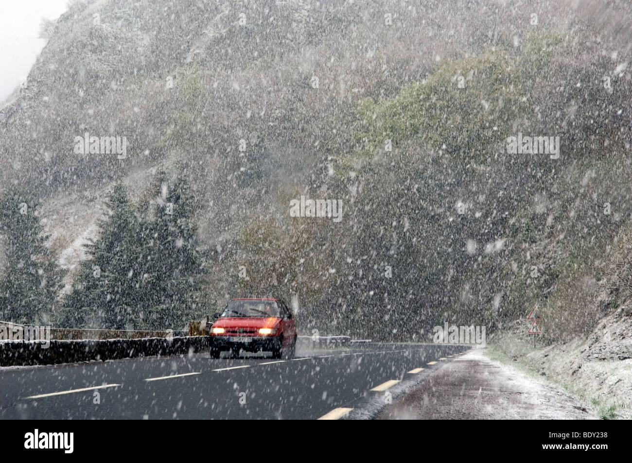 Driving through snow storm Stock Photo - Alamy