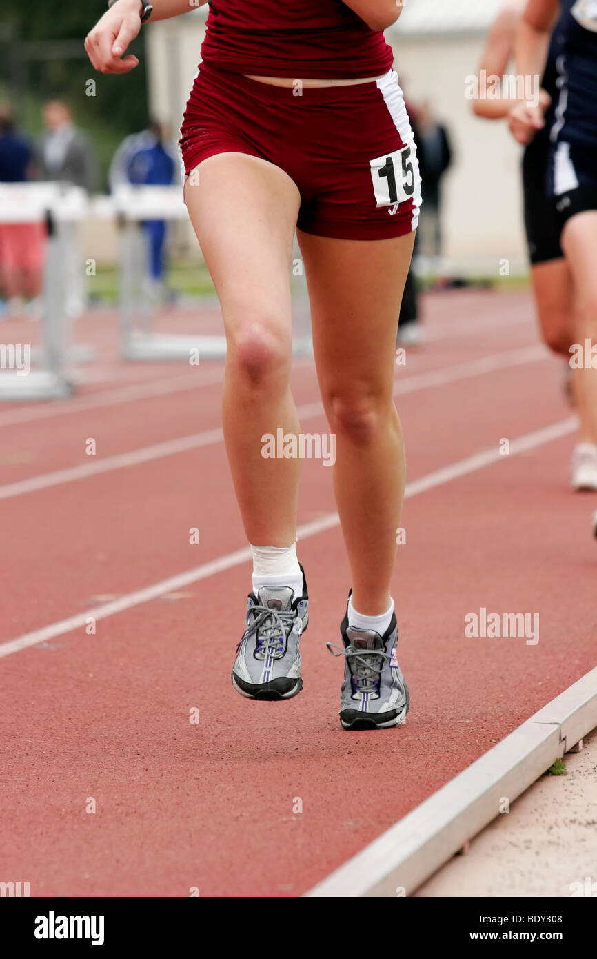 Female track athlete leading a race event Stock Photo - Alamy