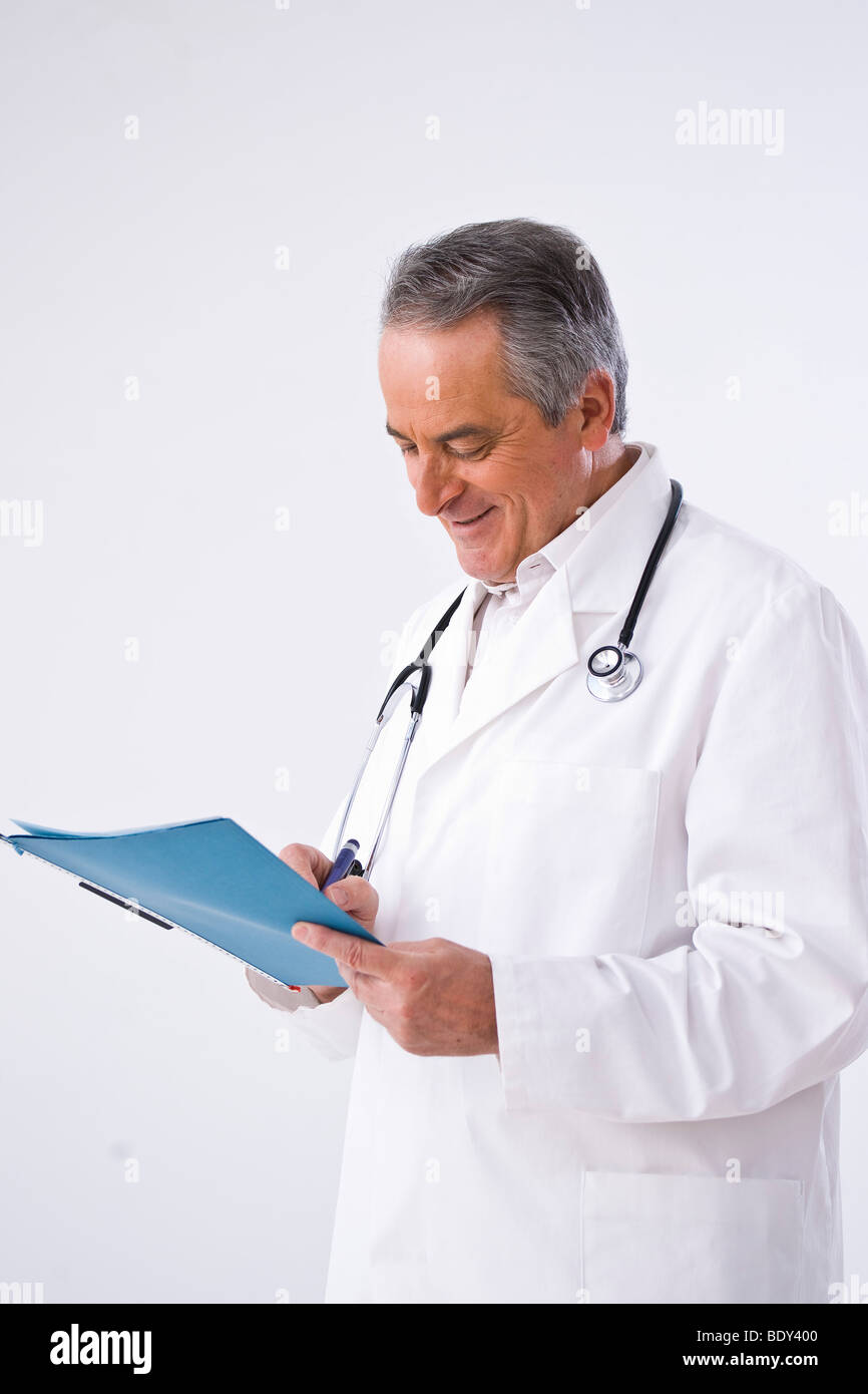 Physician with stethoscope checking a patient's records Stock Photo - Alamy