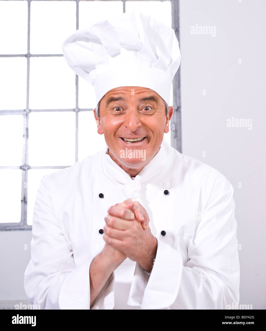 Laughing chef with chef's hat Stock Photo - Alamy