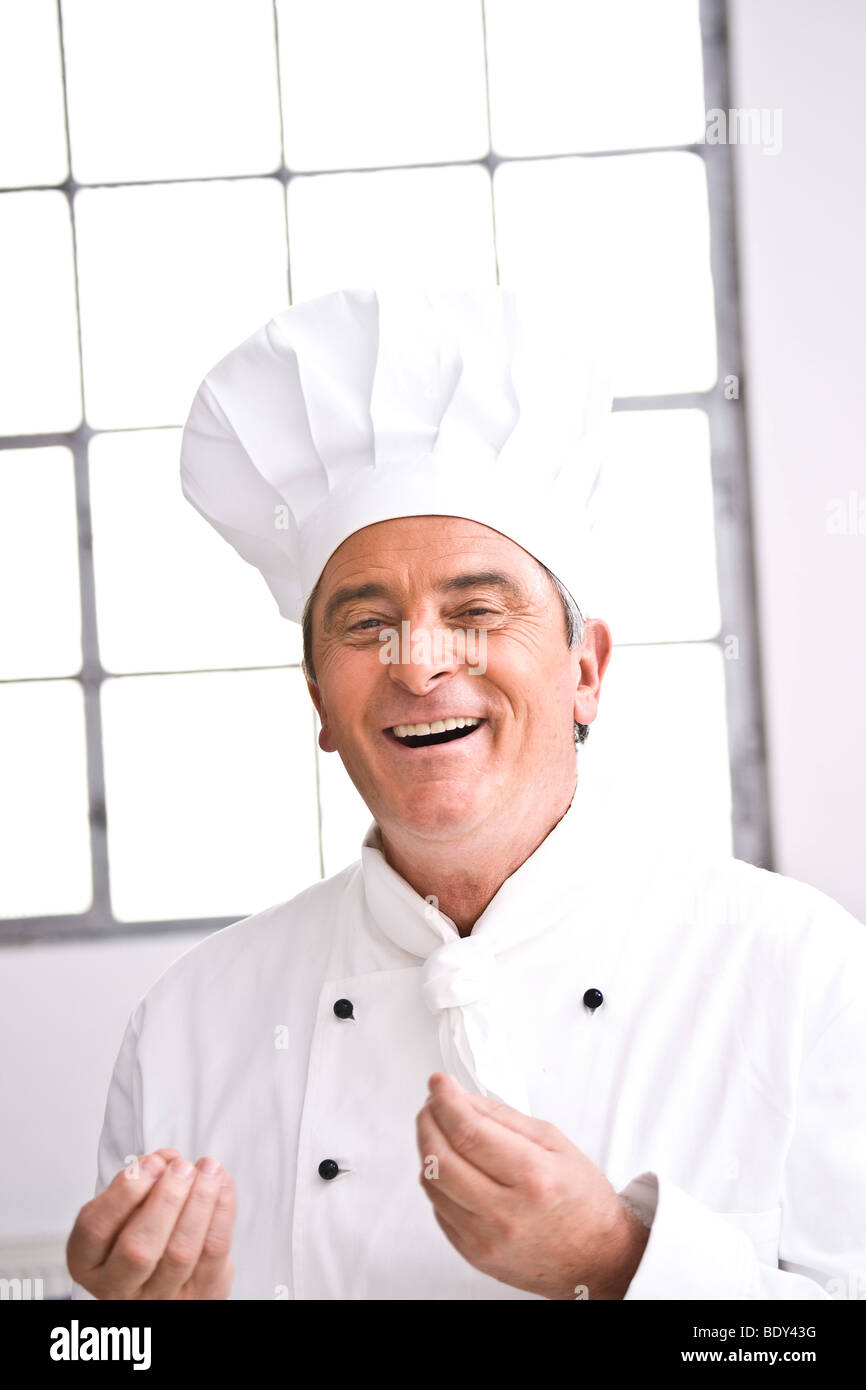 Smiling chef wearing a chef's hat Stock Photo - Alamy