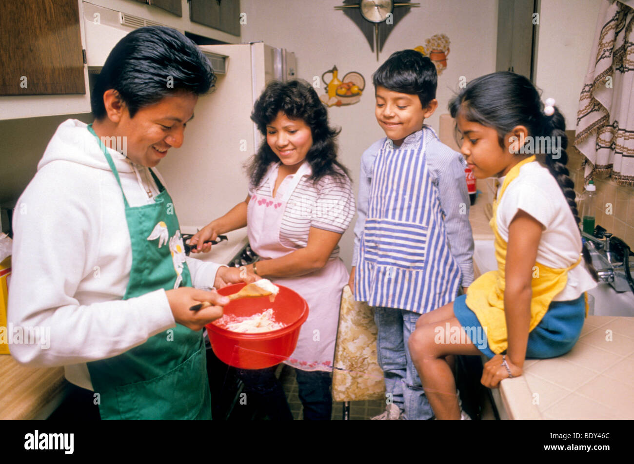 Latin father cook hotcakes for children and wife Stock Photo - Alamy