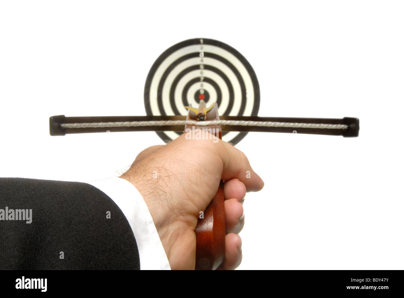 Business man with a crossbow aiming at a target Stock Photo - Alamy