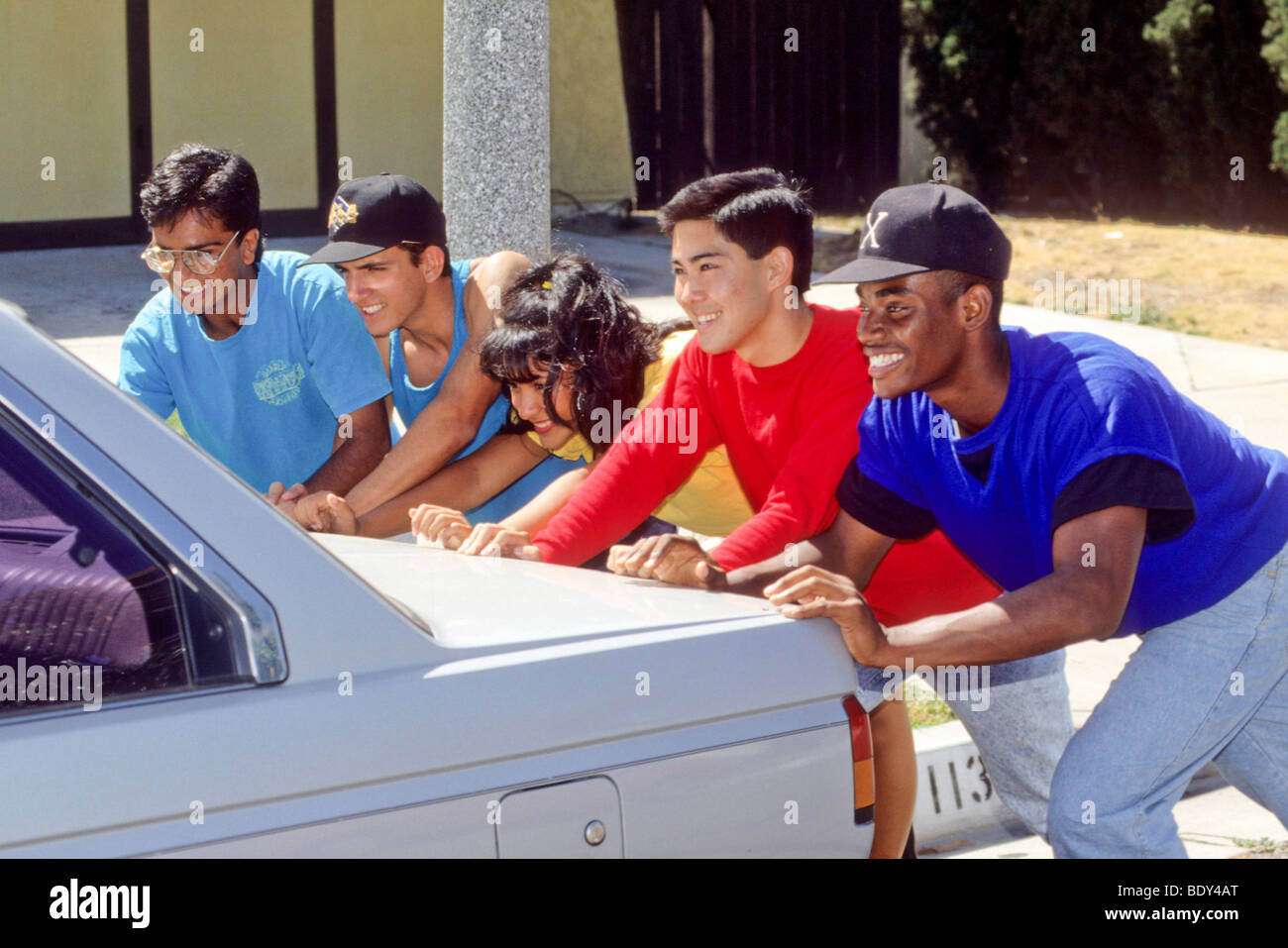 push car together help assist aid each other Stock Photo - Alamy
