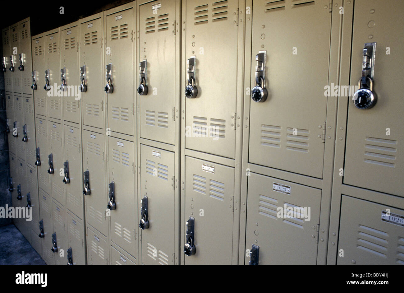 row of beige school lockers with locks on handles Stock Photo - Alamy