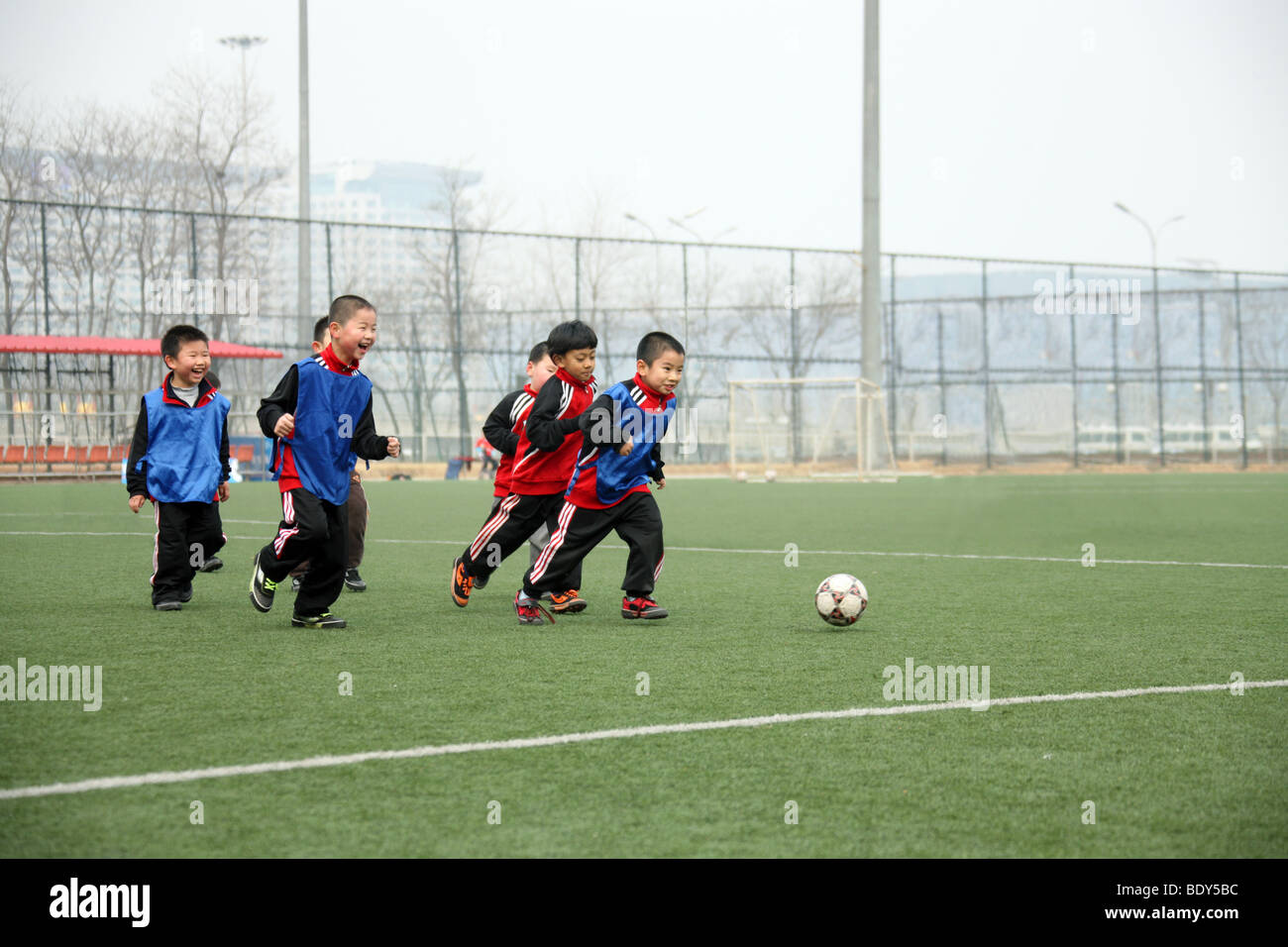 Chinese child kicking ball hi-res stock photography and images - Alamy