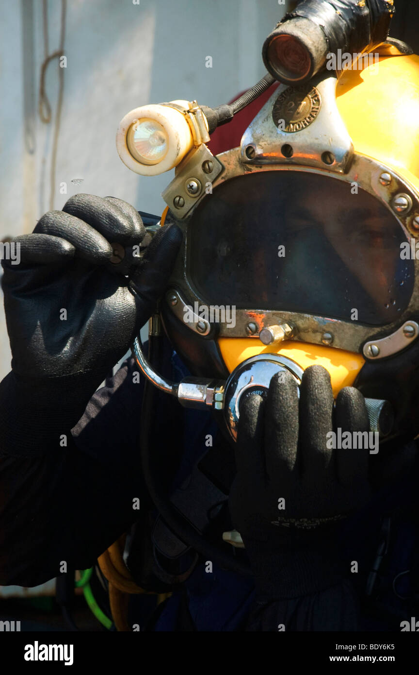 Commercial diver gets ready for a dive The diver is using a helmet ...