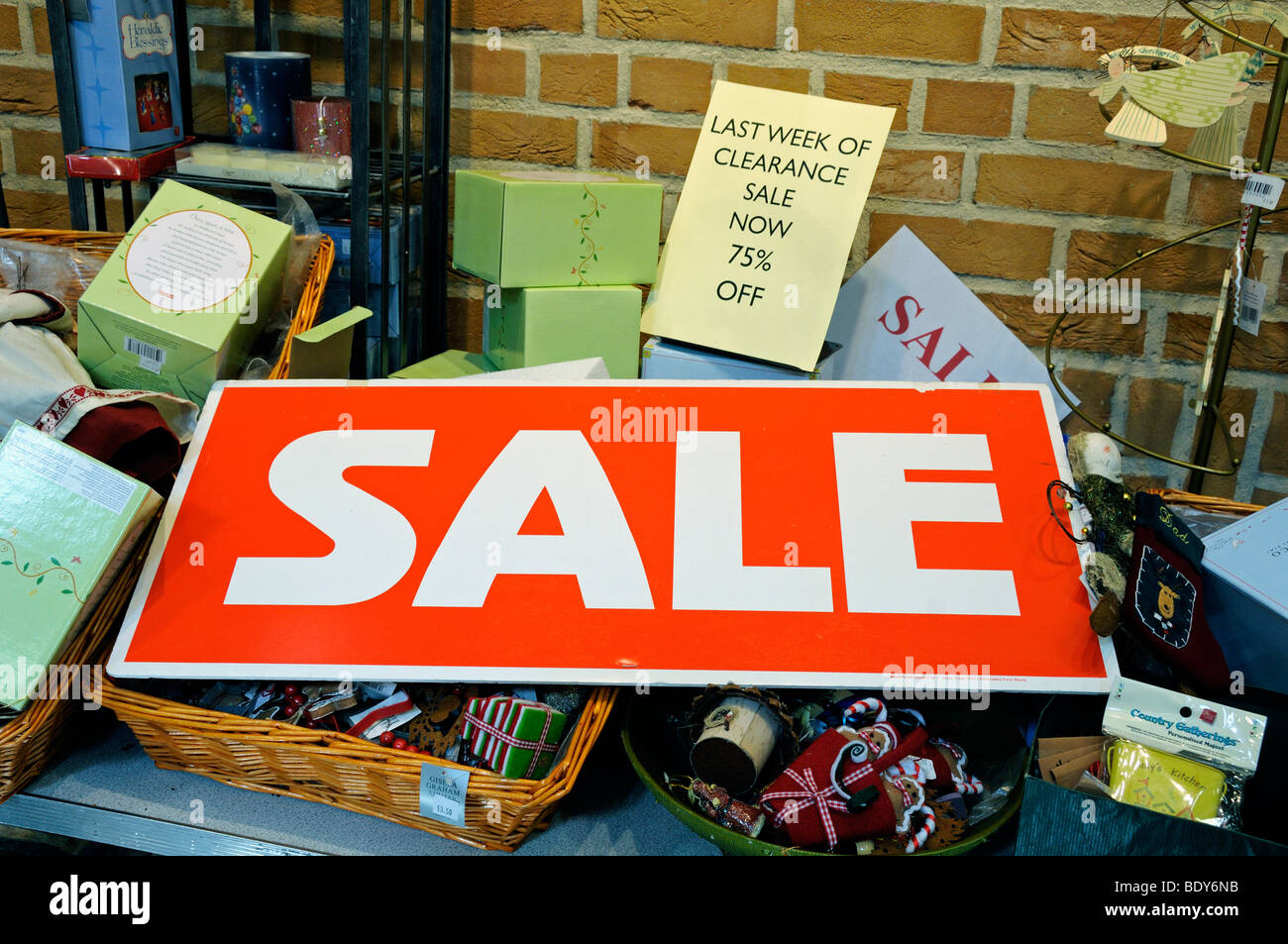 Sale sign in red and white on stall with goods behind Stock Photo - Alamy