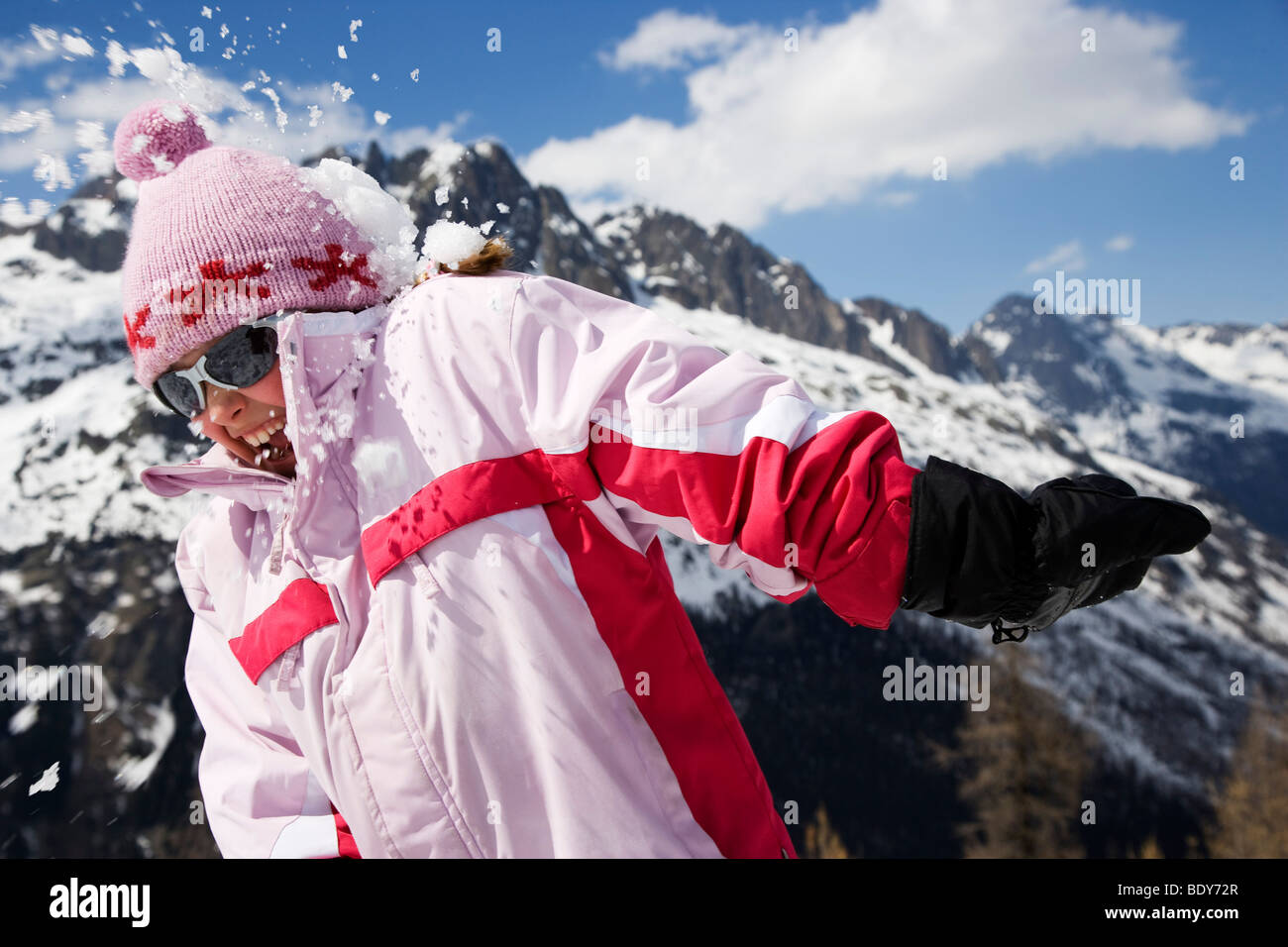 Girl in pink hit by snowball Stock Photo - Alamy