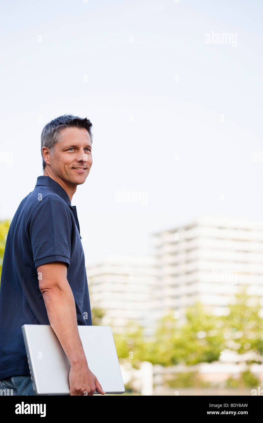 Man Walking With Laptop Stock Photo - Alamy