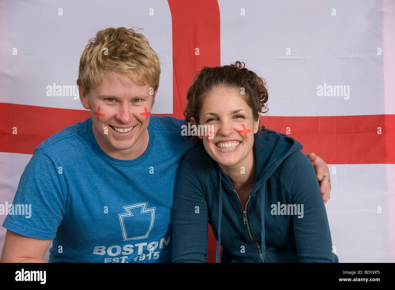 Couple smiling with English flag Stock Photo - Alamy