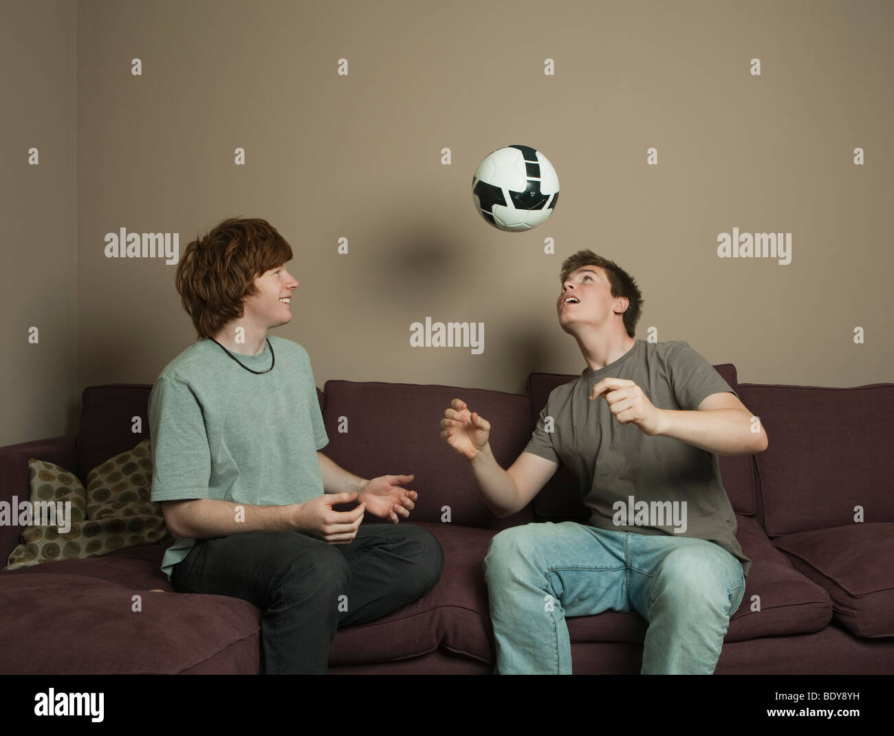 Boys playing football indoors Stock Photo - Alamy