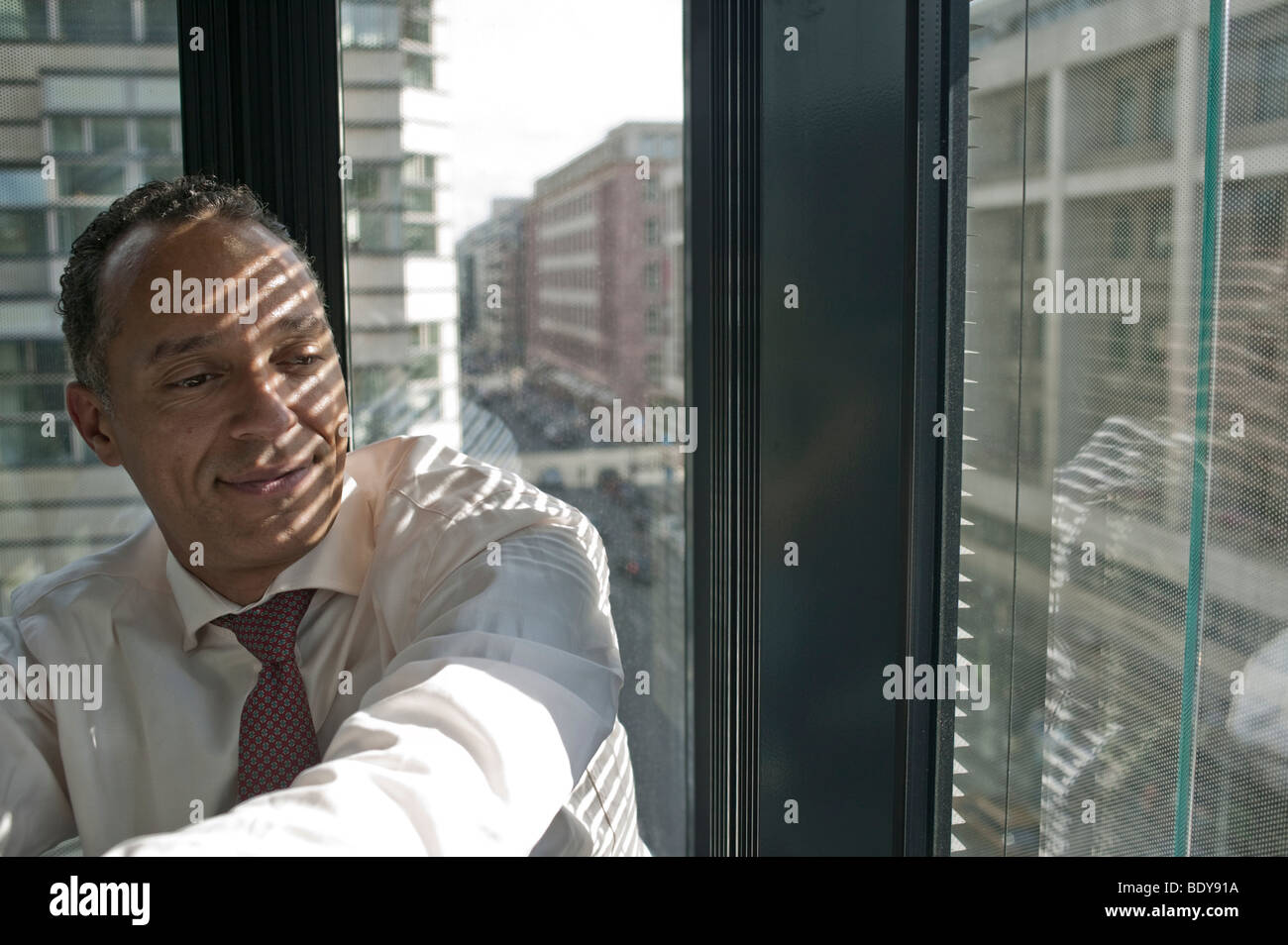 man leaning at window smiling Stock Photo - Alamy