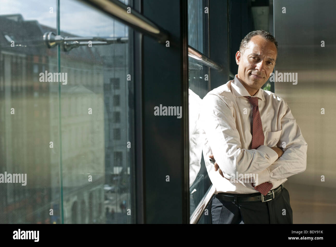 man leaning at window smiling Stock Photo - Alamy