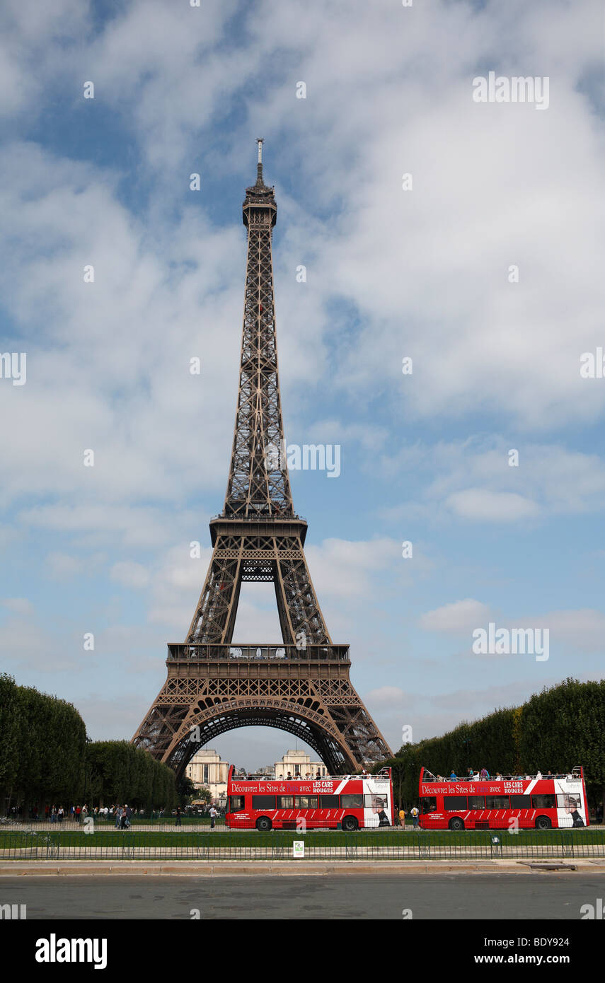 Eiffel Tower against a blue sky with two red buses, Paris, France ...